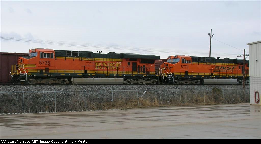BNSF 5735 and 5771 leading train of MBKX hoppers waiting for clearance in the rain